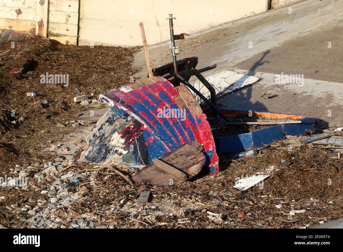 Partial remains of wrecked old boat washed up on shore with other ...