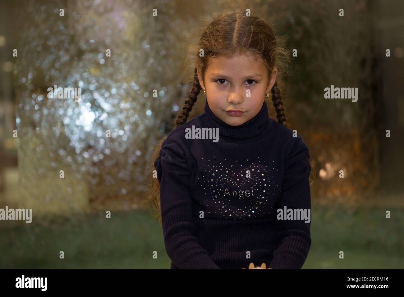 A small blonde girl looks thoughtfully into the distance Stock Photo ...