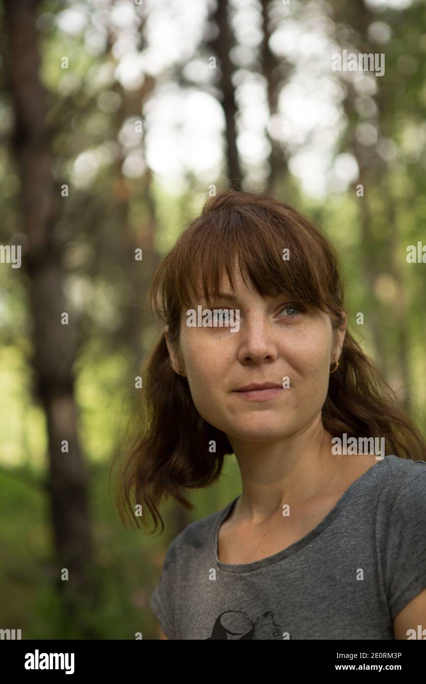 A picture of the face of a pensive pretty brunette woman standing ...