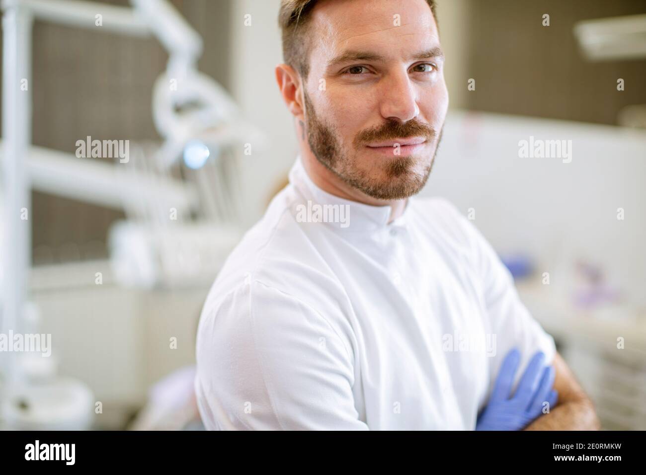 Handsome dentist posing in the modern dental office Stock Photo - Alamy