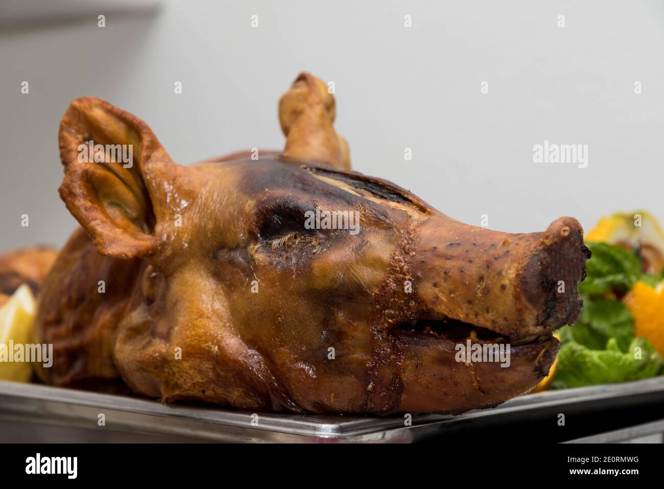 Suckling Pig - Roasted Pork Head Served On A Tray Stock Photo - Alamy