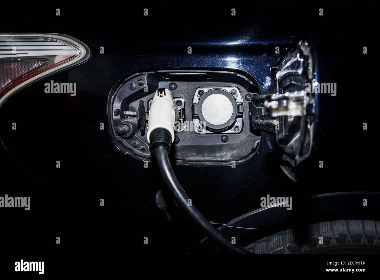 A car recharges its electric batteries, detail of the connected plug ...