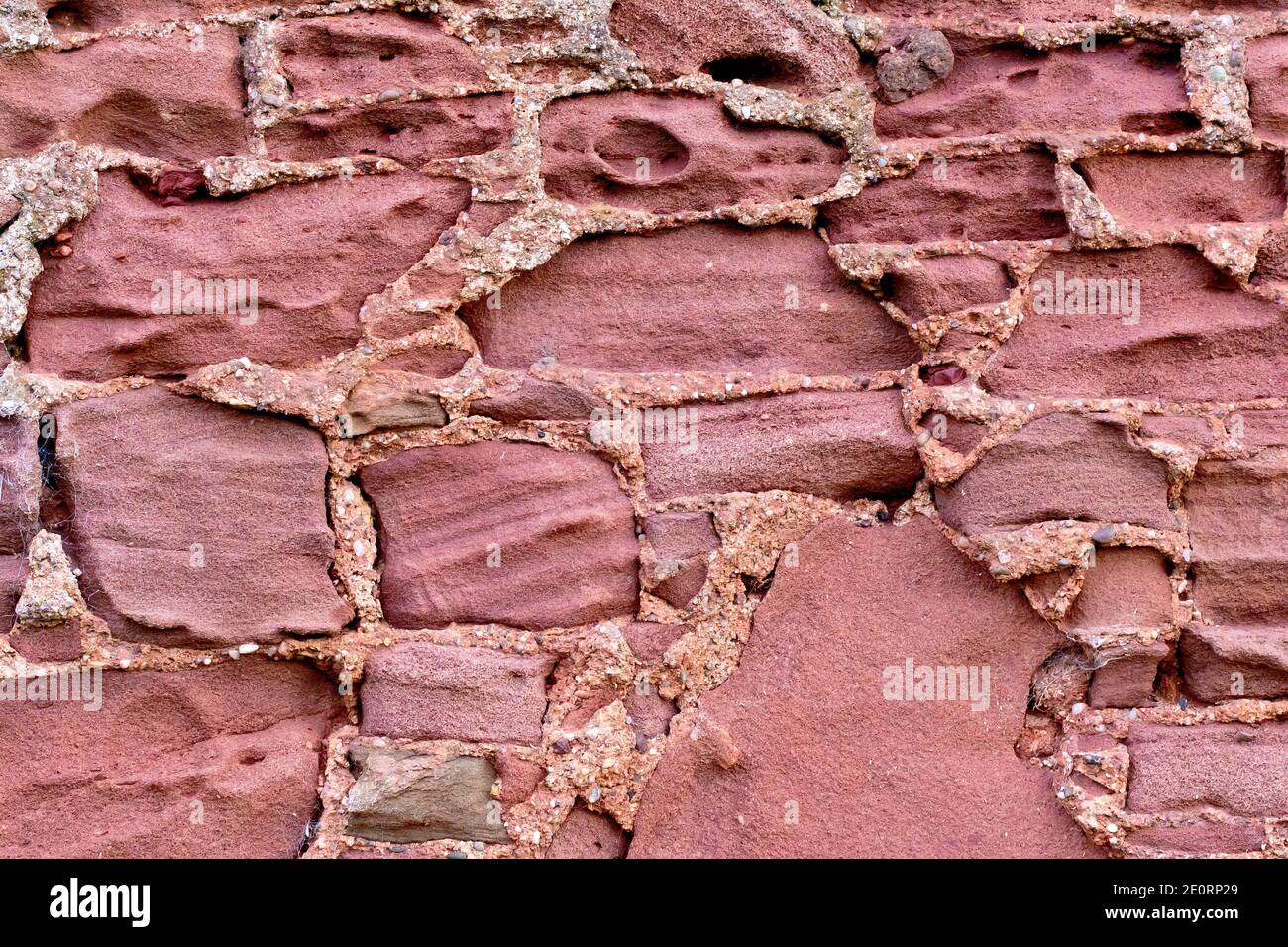 An old sandstone wall, showing the haphazard construction using all ...