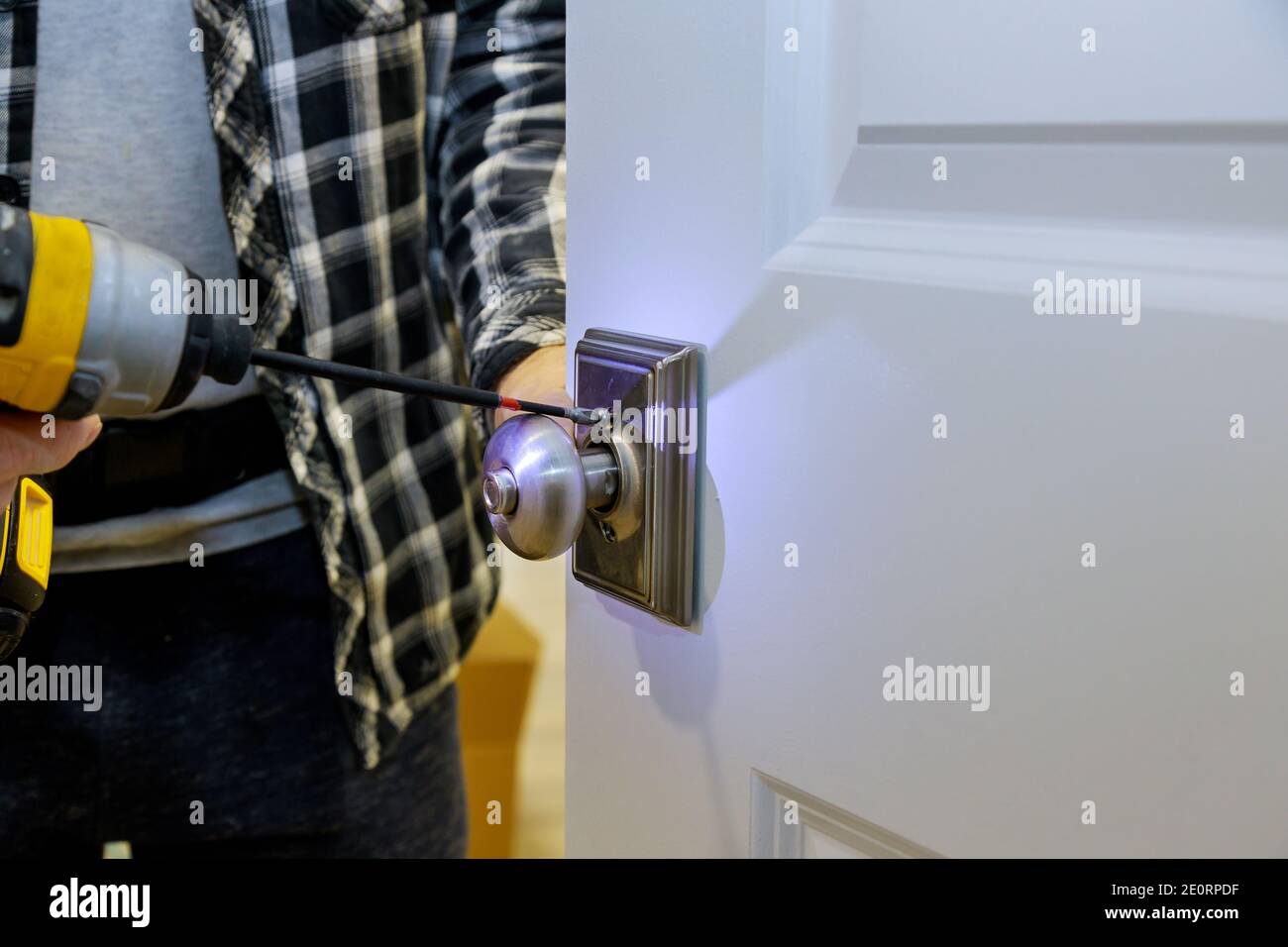 Carpenter installation at interior wood door lock of an apartment Stock ...