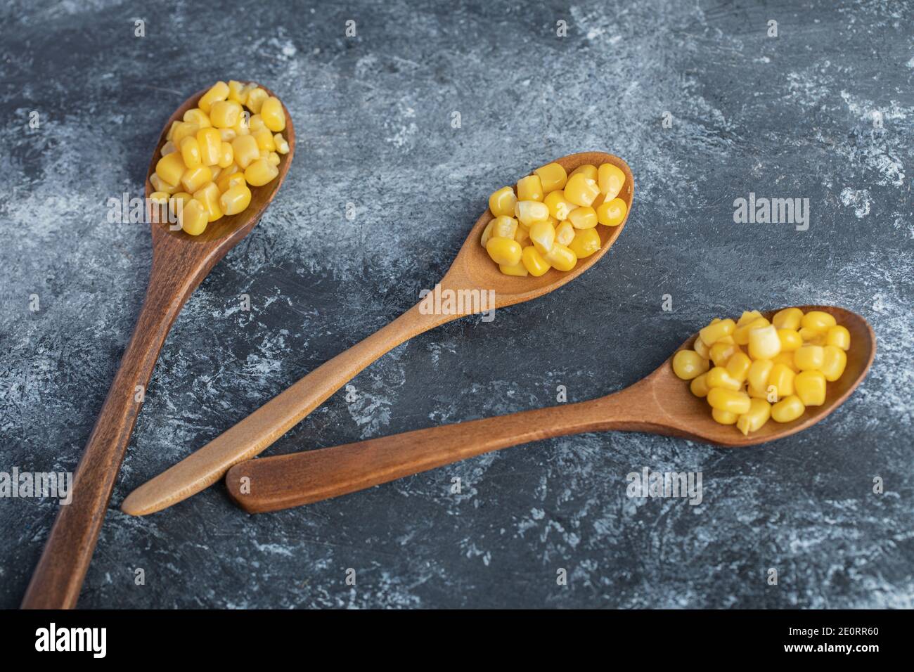 Delicious sweet corn on wooden spoons Stock Photo - Alamy