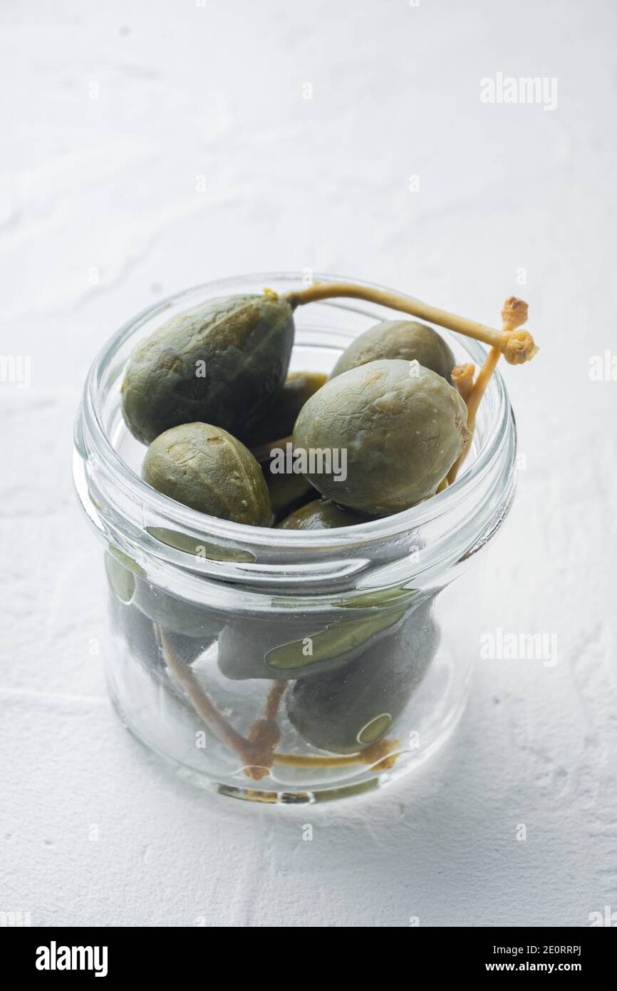 Capers, marinated in oil, on white background Stock Photo - Alamy
