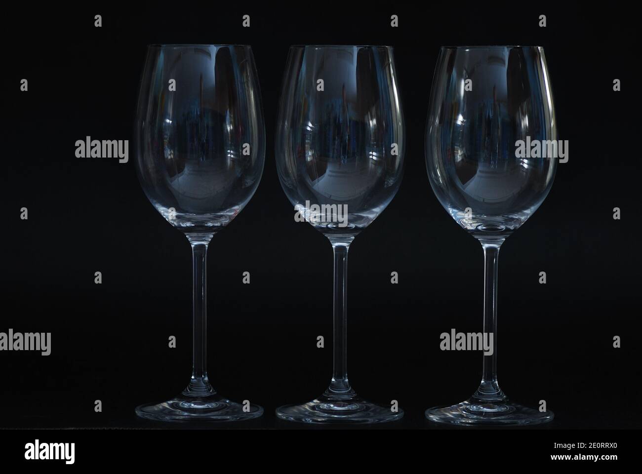 three empty glasses of wine on black background normal Stock Photo - Alamy