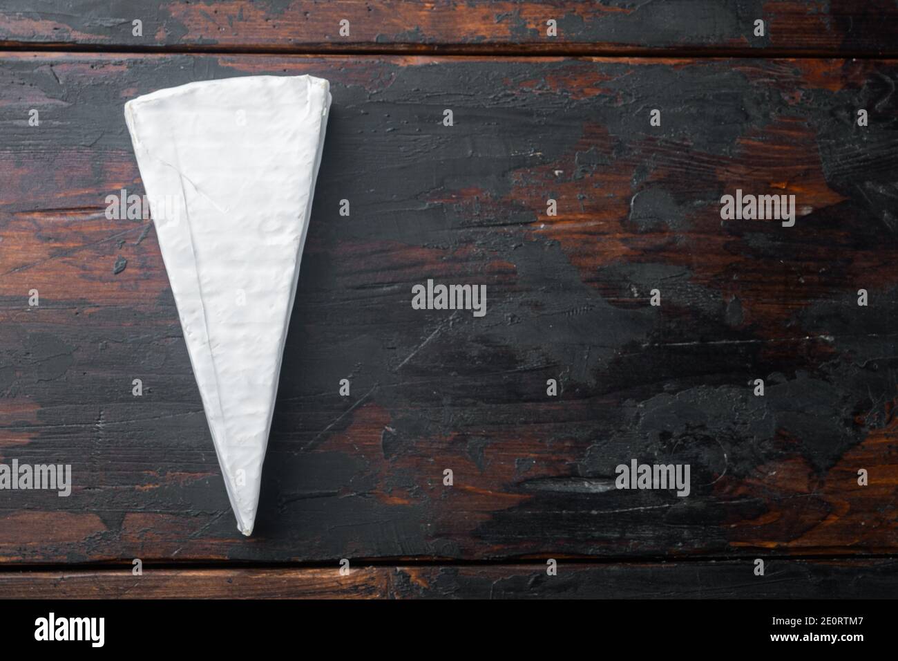 Brie type of cheese set, on old wooden table, flat lay with copy space ...