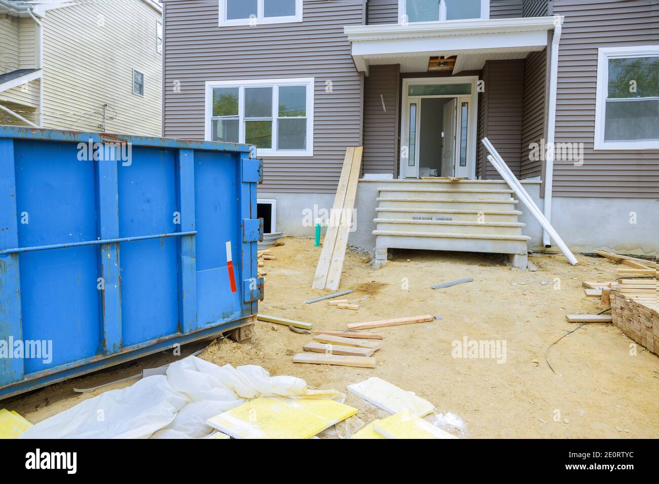 Dumpsters construction garbage in a wood frame structure of Incomplete ...
