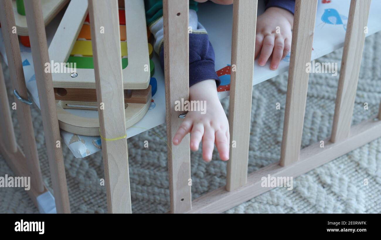 Small Child Trying To Reach Something Out Of A Wooden Cot Stock Photo ...