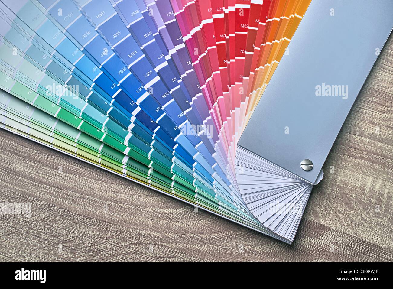 Color wheel palette for choosing paint tone. Various colors on wooden ...