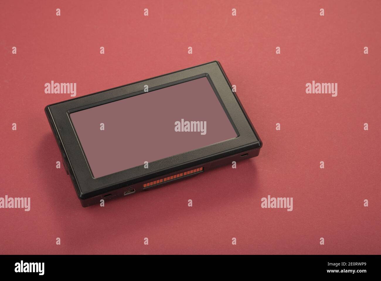 Old GPS navigation on a red background Stock Photo - Alamy