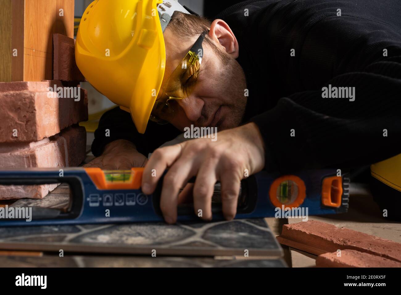 Very close. While laying the terracotta, the general construction worker checks the correctness ...