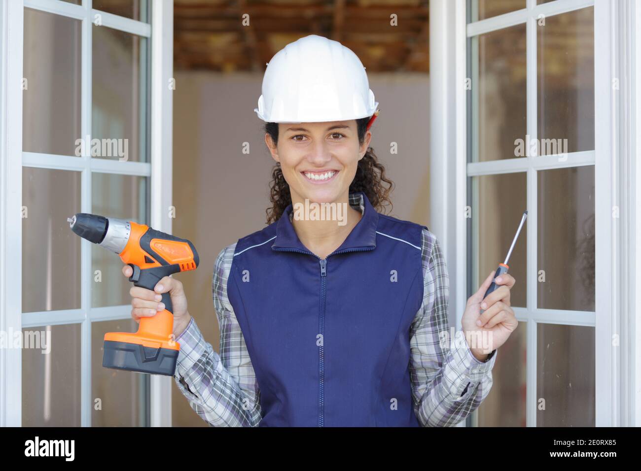 Happy woman builder tools hi-res stock photography and images - Alamy