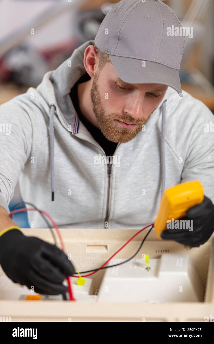 male electrician using multimeter on main meter Stock Photo - Alamy