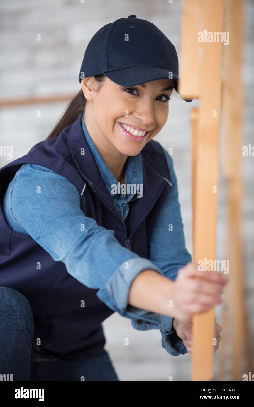 female builder working with a wood framework Stock Photo - Alamy