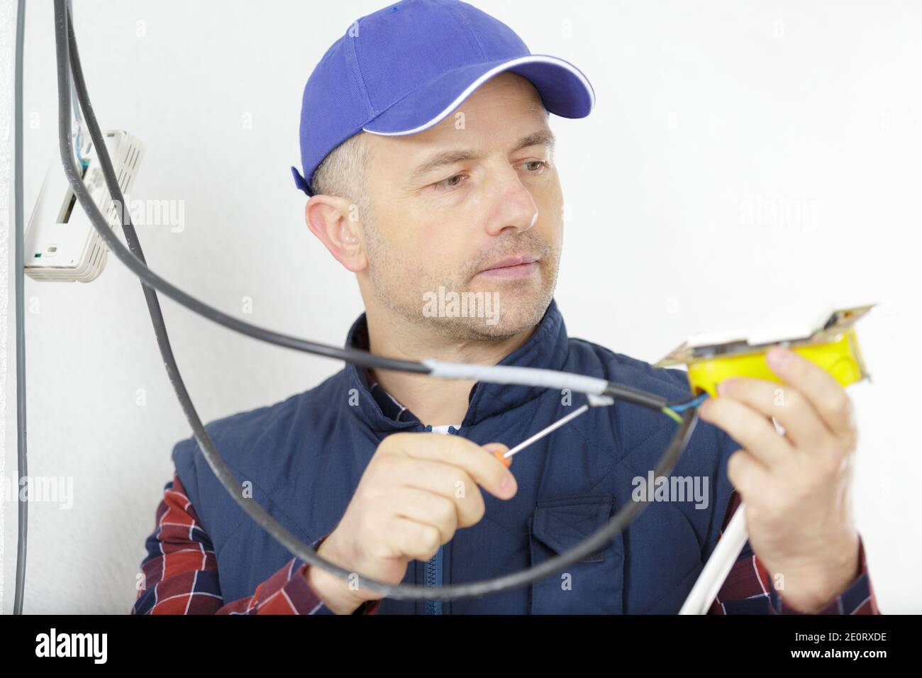 male electrician at work laying wiring cable Stock Photo - Alamy