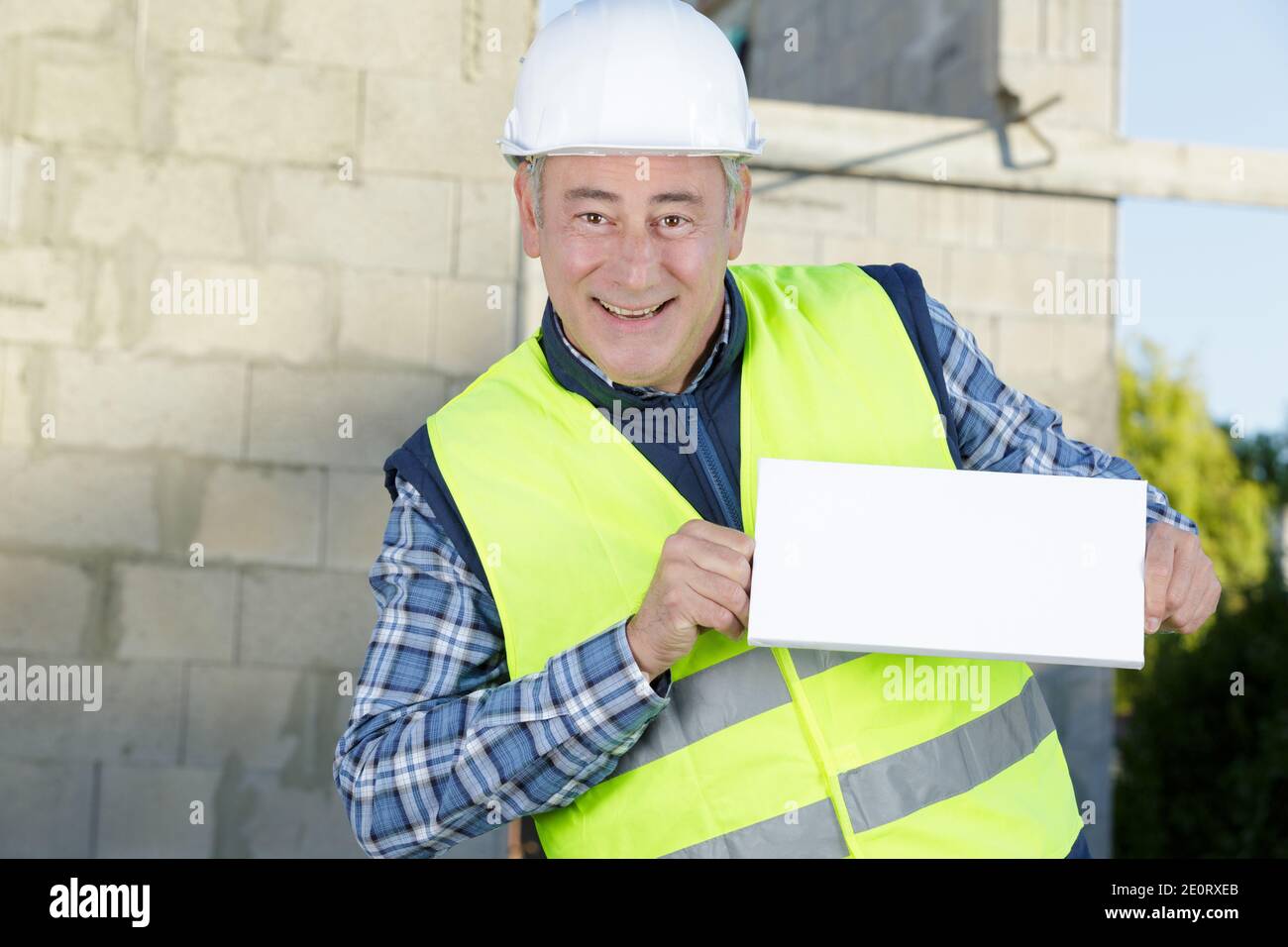 happy builder showing a sign Stock Photo - Alamy
