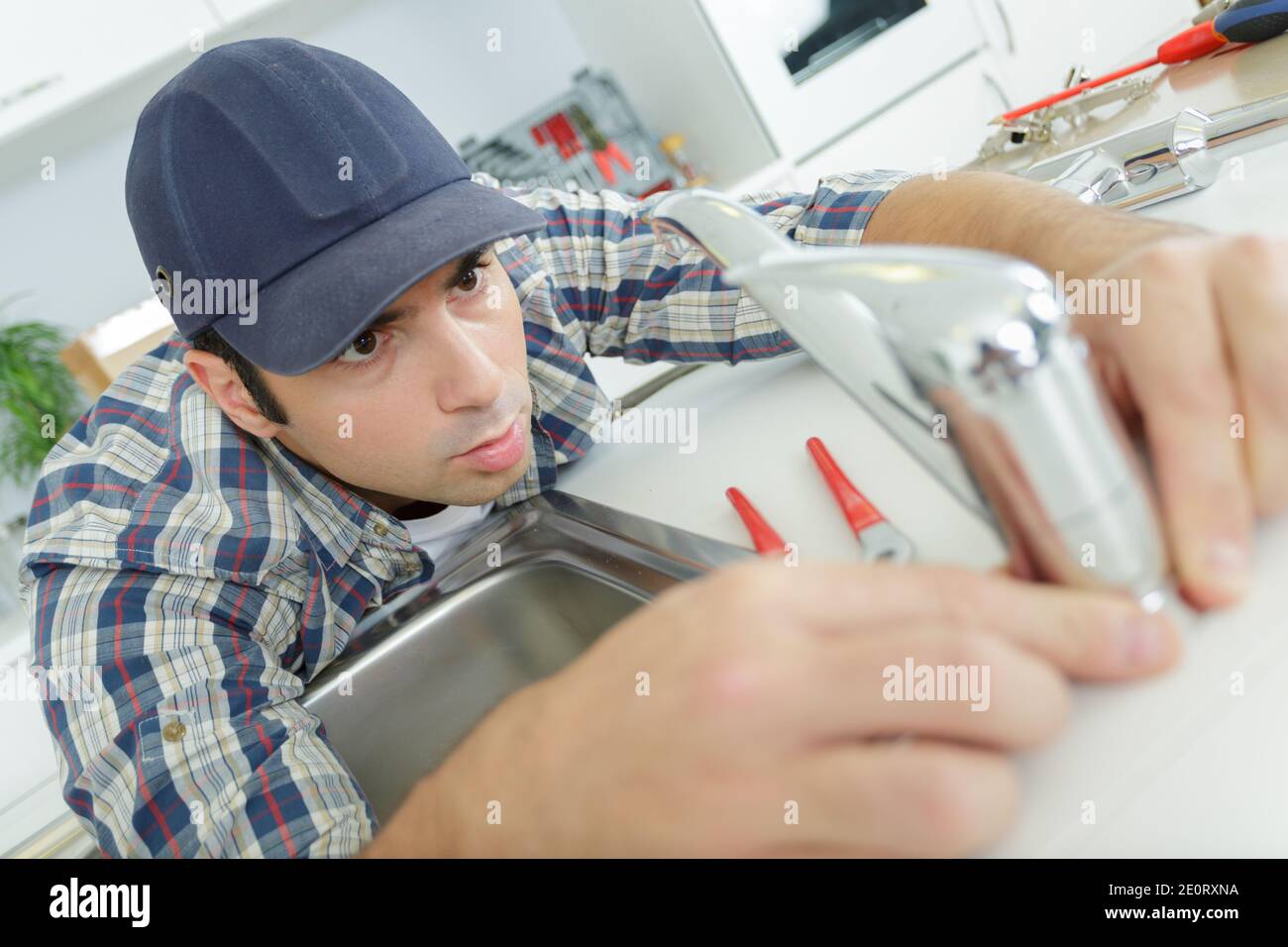 Man fixing sink pipe hi-res stock photography and images - Alamy