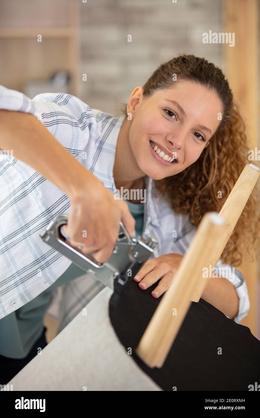 woman repairing chair with stapler Stock Photo - Alamy