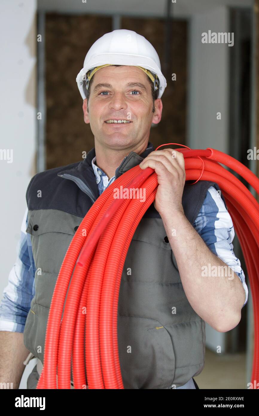 man in uniform holds pipes Stock Photo - Alamy