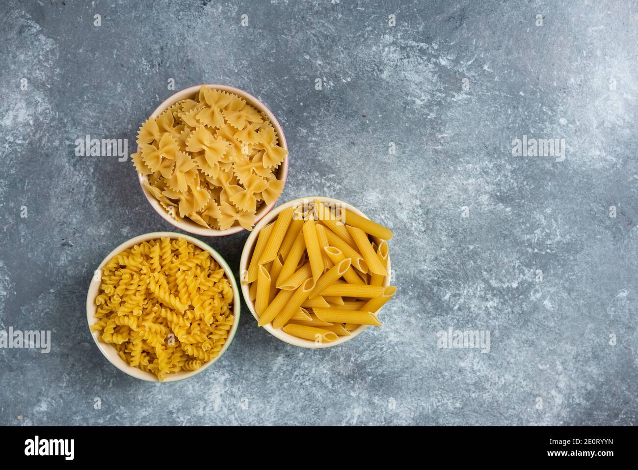 Different types of raw macaroni on a marble background Stock Photo - Alamy