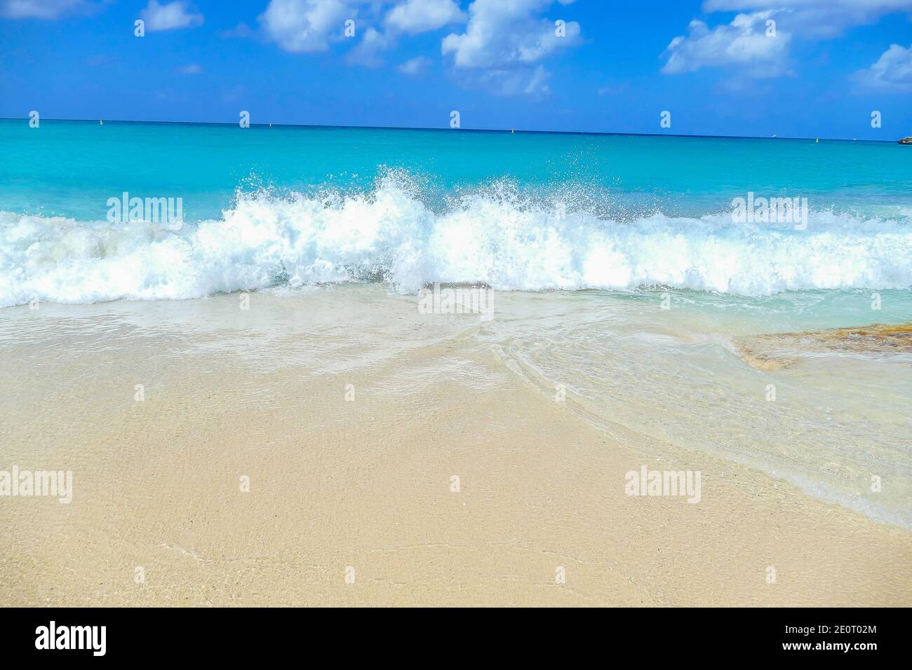Blue crystal blue water splashing on a white sandy beach Stock Photo ...
