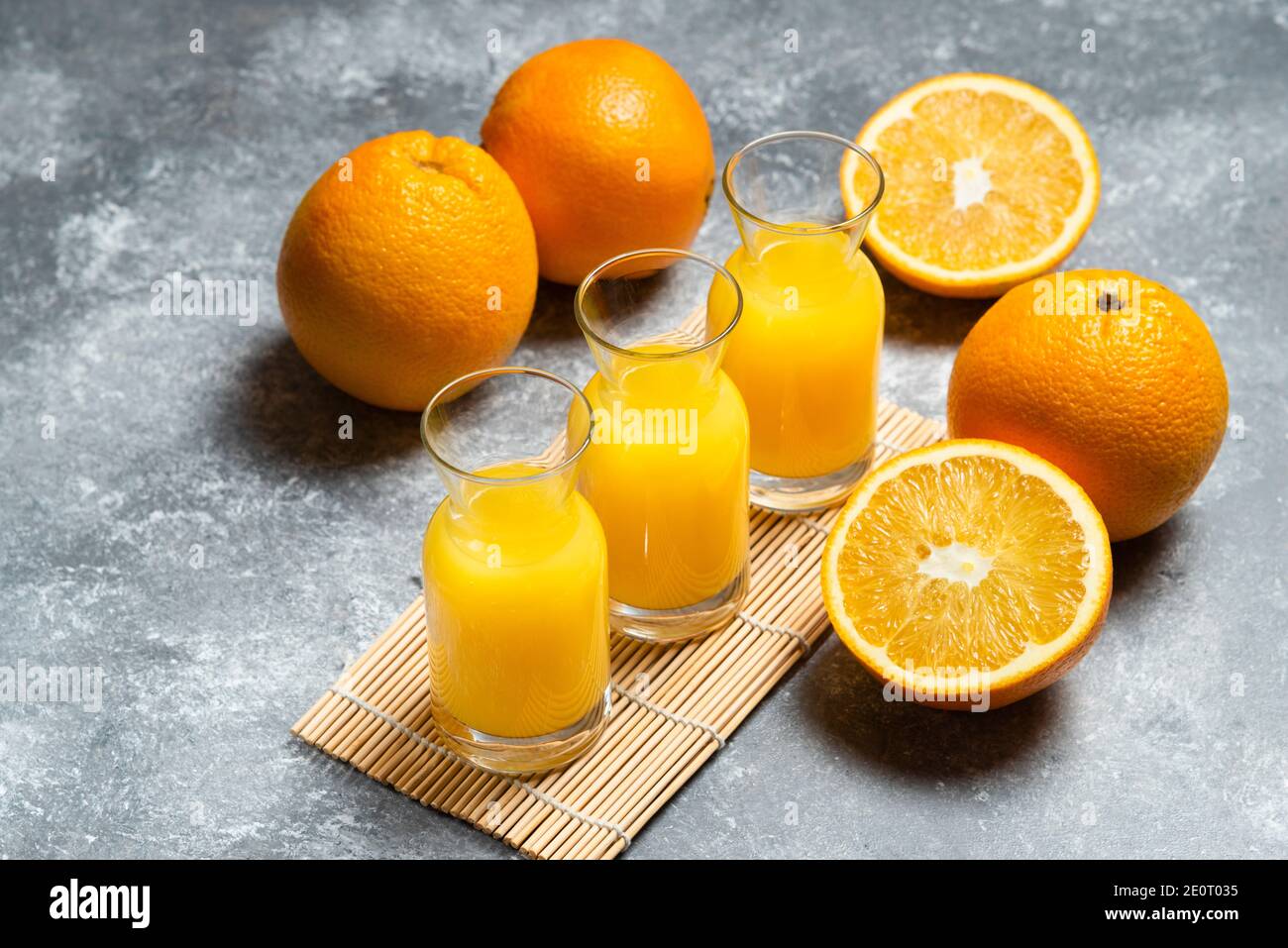 Glass jars of orange juice and sliced orange Stock Photo - Alamy