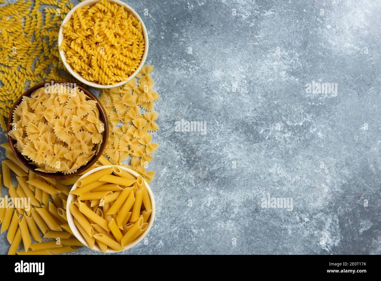 Different types of raw macaroni on a marble background Stock Photo - Alamy
