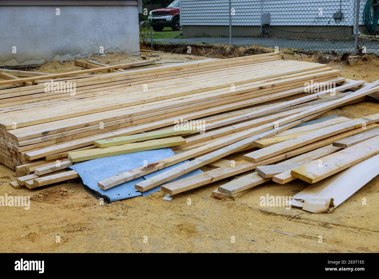 House under construction of stack unloading wooden beams on ...