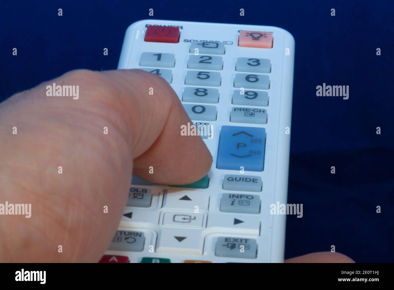 finger presses the button on the remote control, white Stock Photo - Alamy