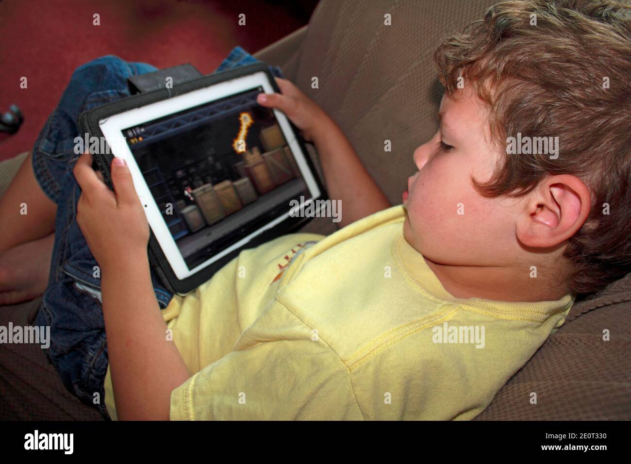 a young boy using a tablet Stock Photo - Alamy