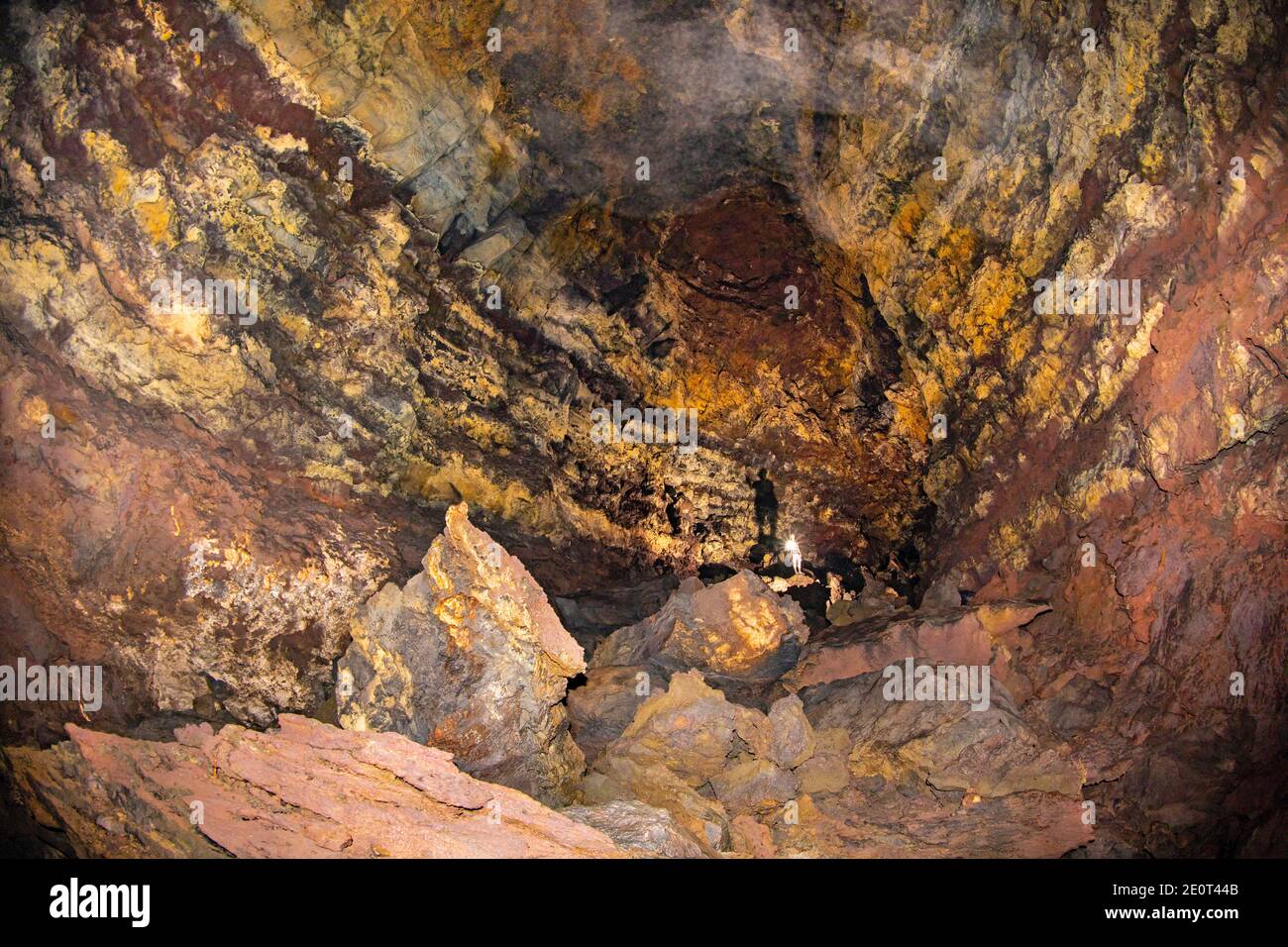 A man (MR) inside a huge cavern that is part of a long lava tube on the ...