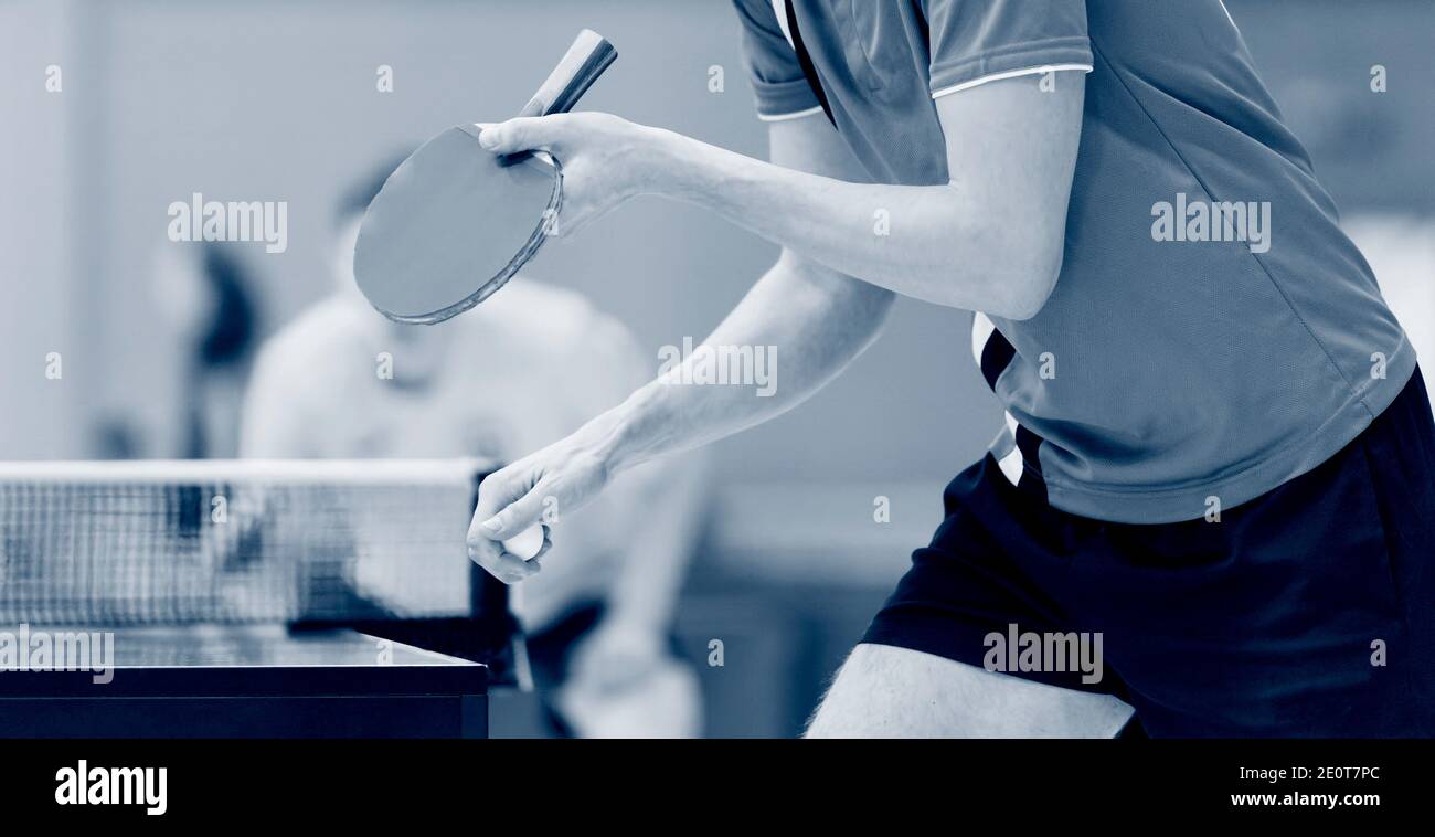 Close up of a man hands holding table tennis rocket and ball. Blue ...