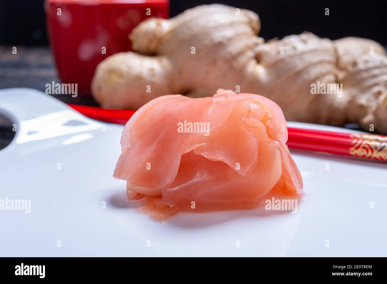 Asian food, pink sliced pickled ginger roots ready to eat, close up ...