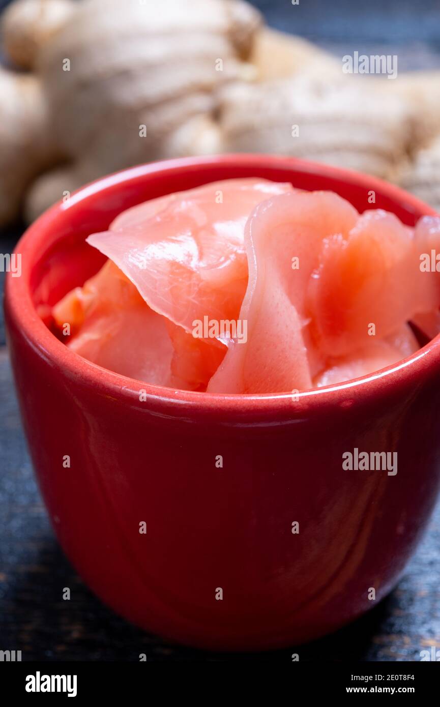 Asian food, pink sliced pickled ginger roots ready to eat, close up ...