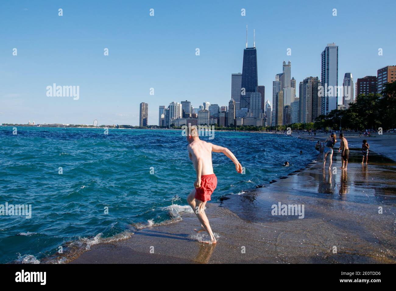Chicago lakefront near North Avenue Beach. Young man running on seawall ...