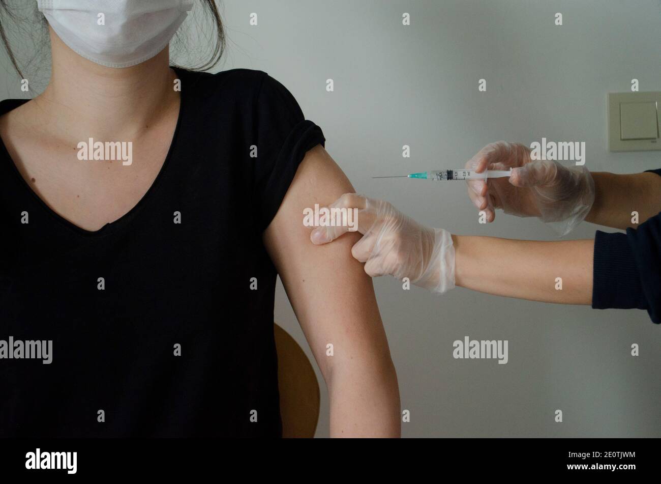 a woman's hand holding a syringe in front of a white background Stock ...