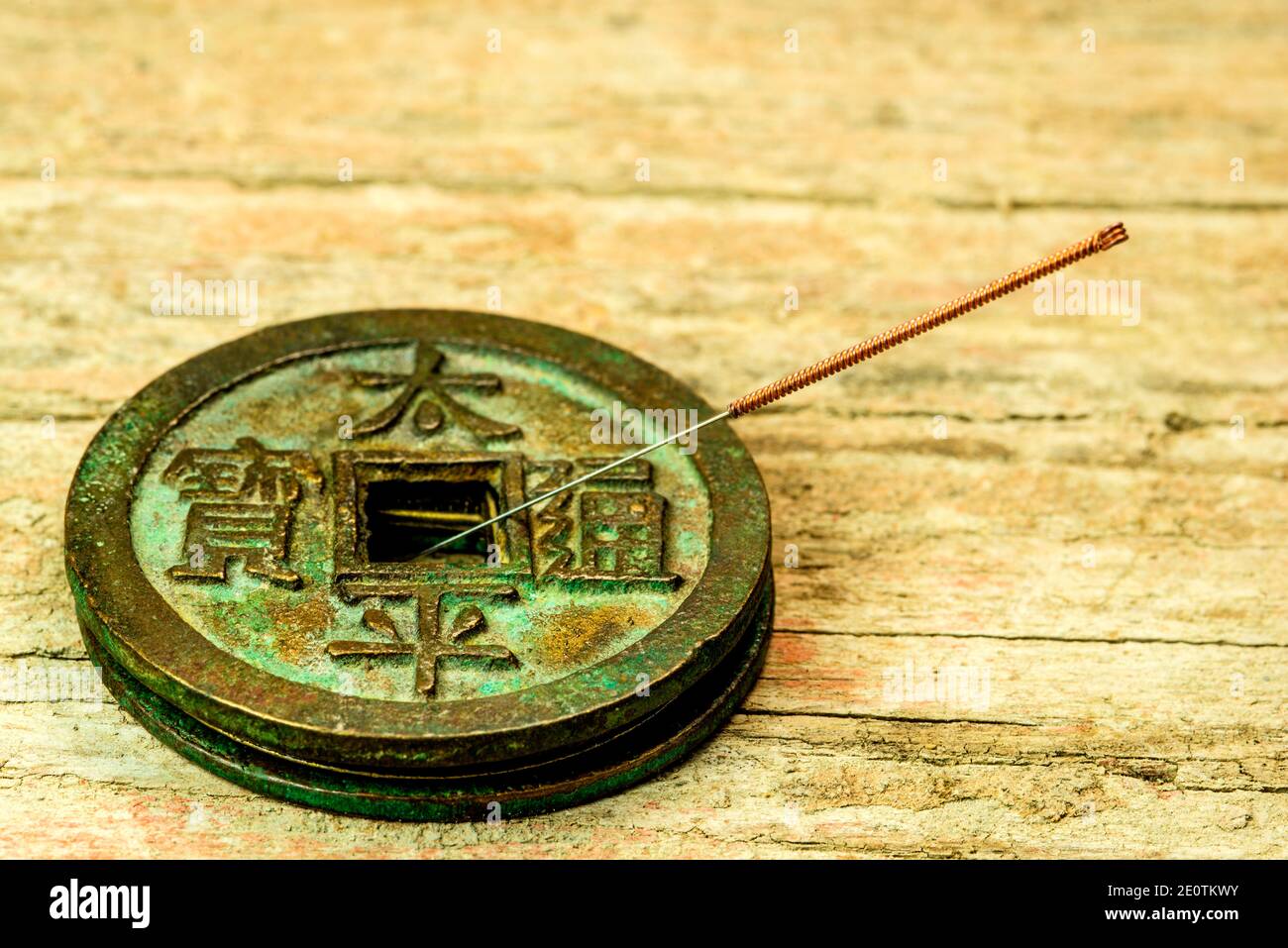 Acupuncture Needle On Antique Chinese Coin Stock Photo - Alamy