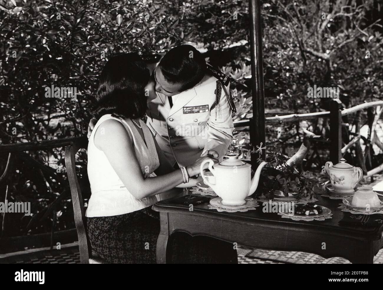 Prince Norodom Sihanouk kisses his wife princess Monique while acting ...