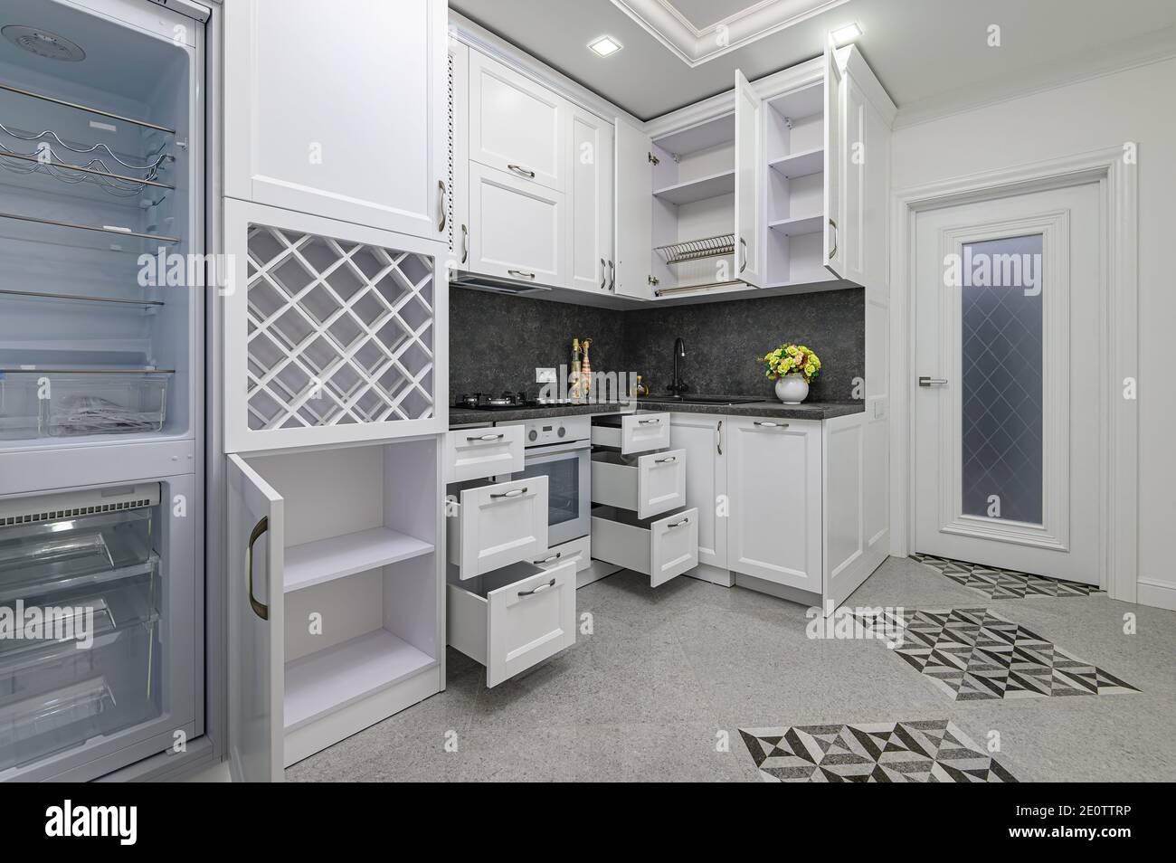 Open doors and drawers open at modern white kitchen Stock Photo - Alamy