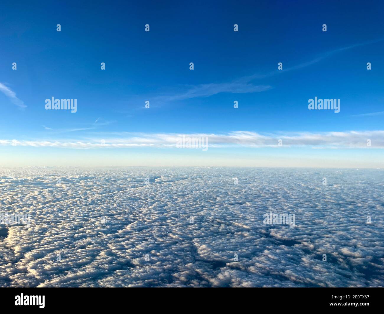 An aerial view from an airplane window of clouds with bright blue skies Stock Photo - Alamy