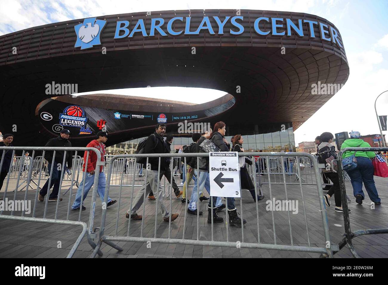 People wait in line for free shuttle bus service to Manhattan at The ...