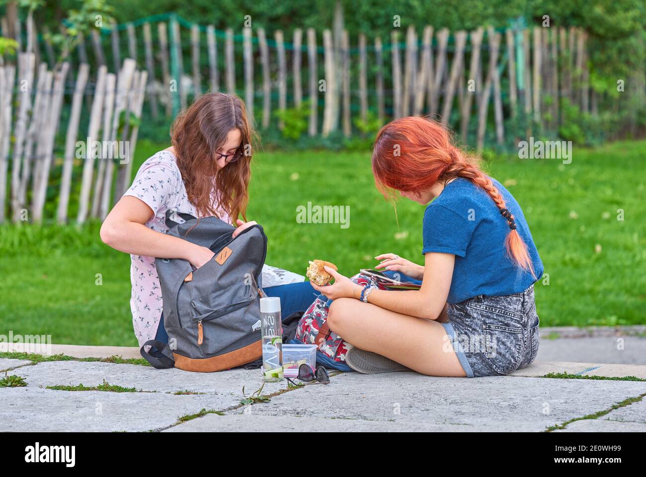Girl friends taking a break in the city Stock Photo - Alamy