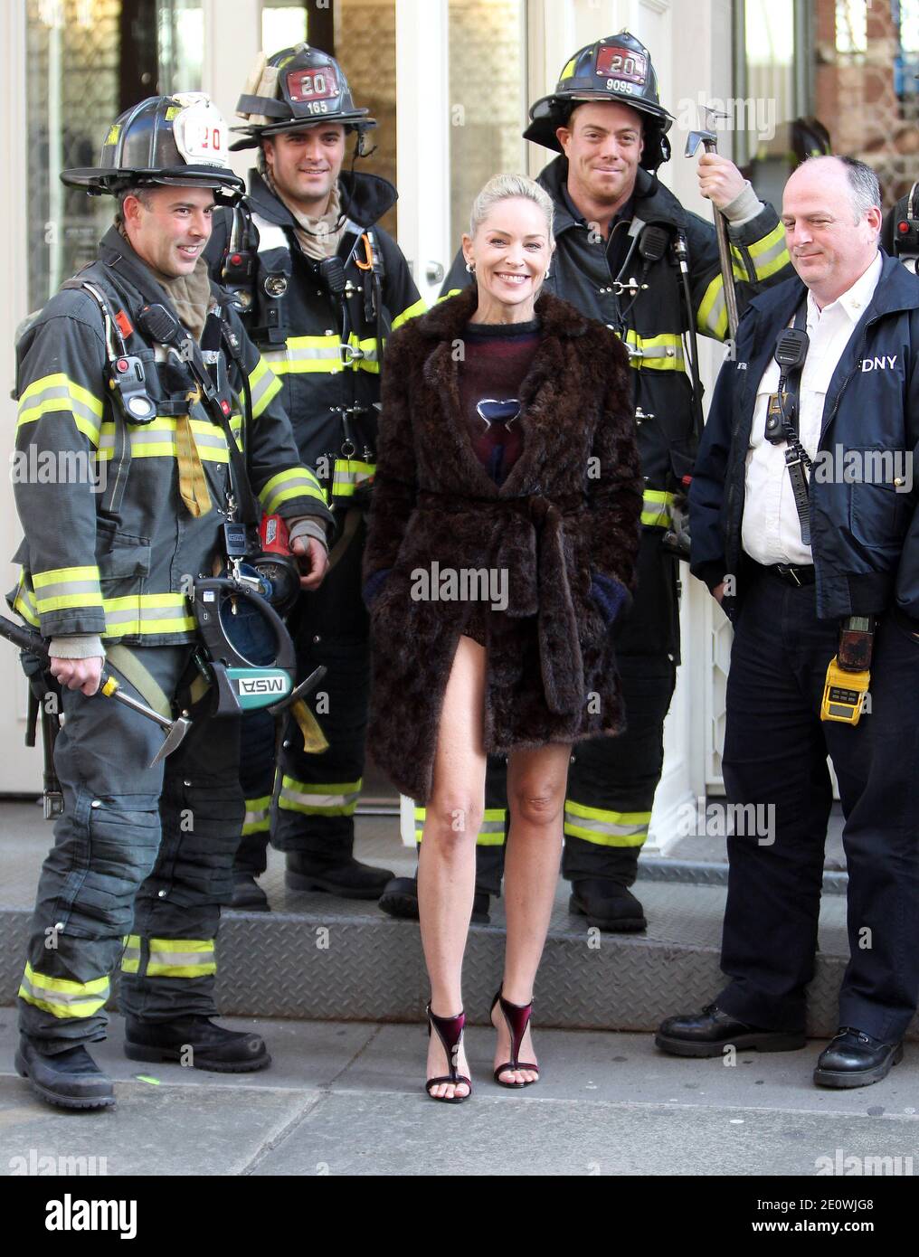 U.S actress Sharon Stone poses with New York firefighters on her way to ...