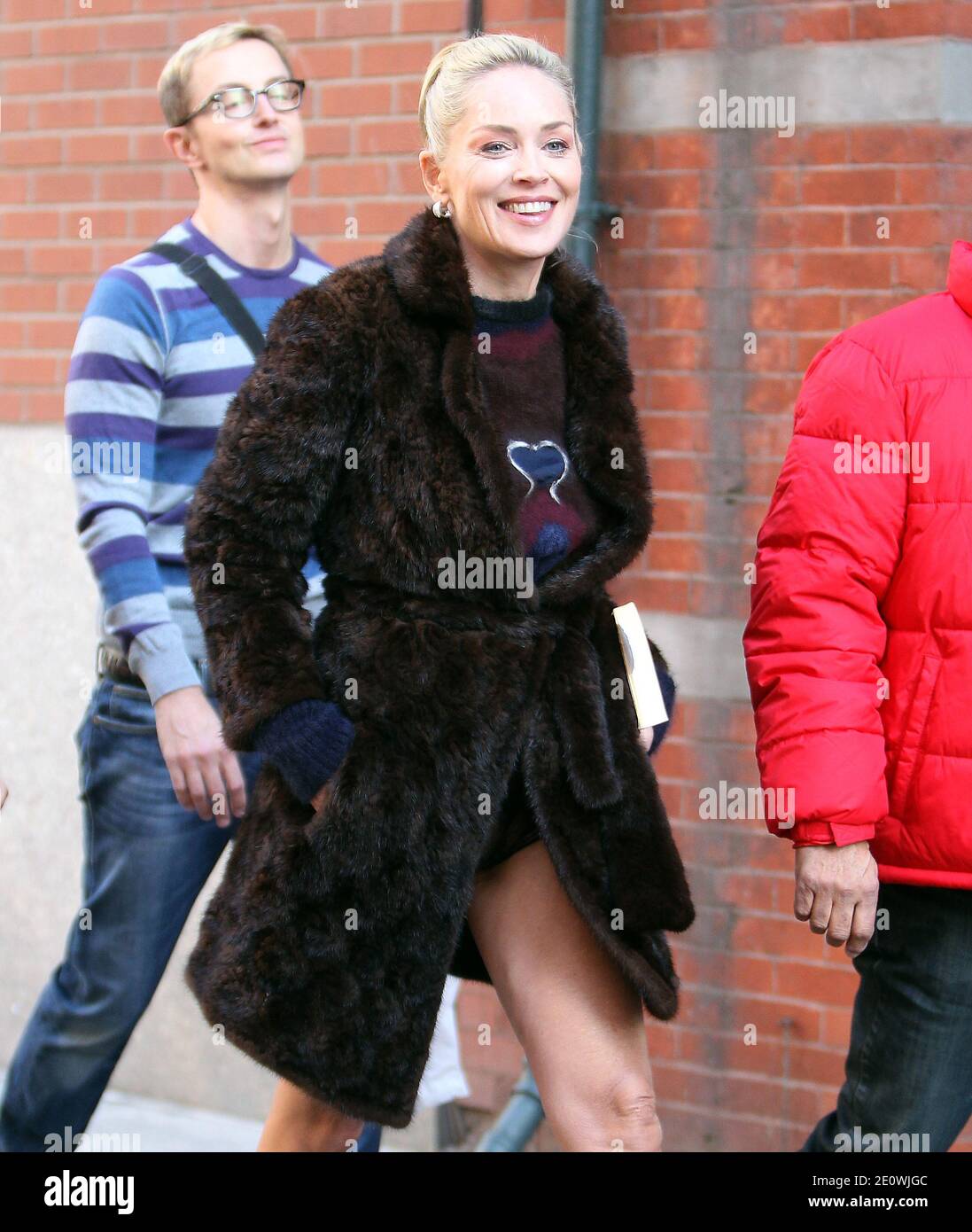 U.S actress Sharon Stone poses with New York firefighters on her way to ...