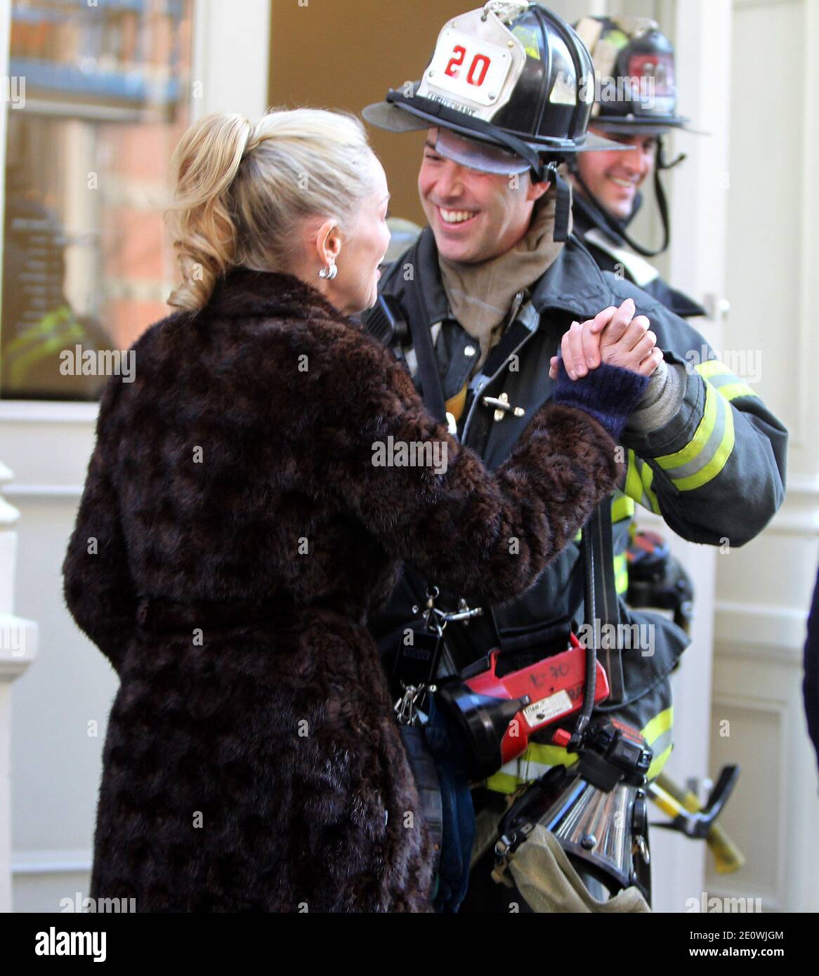 U.S actress Sharon Stone poses with New York firefighters on her way to ...
