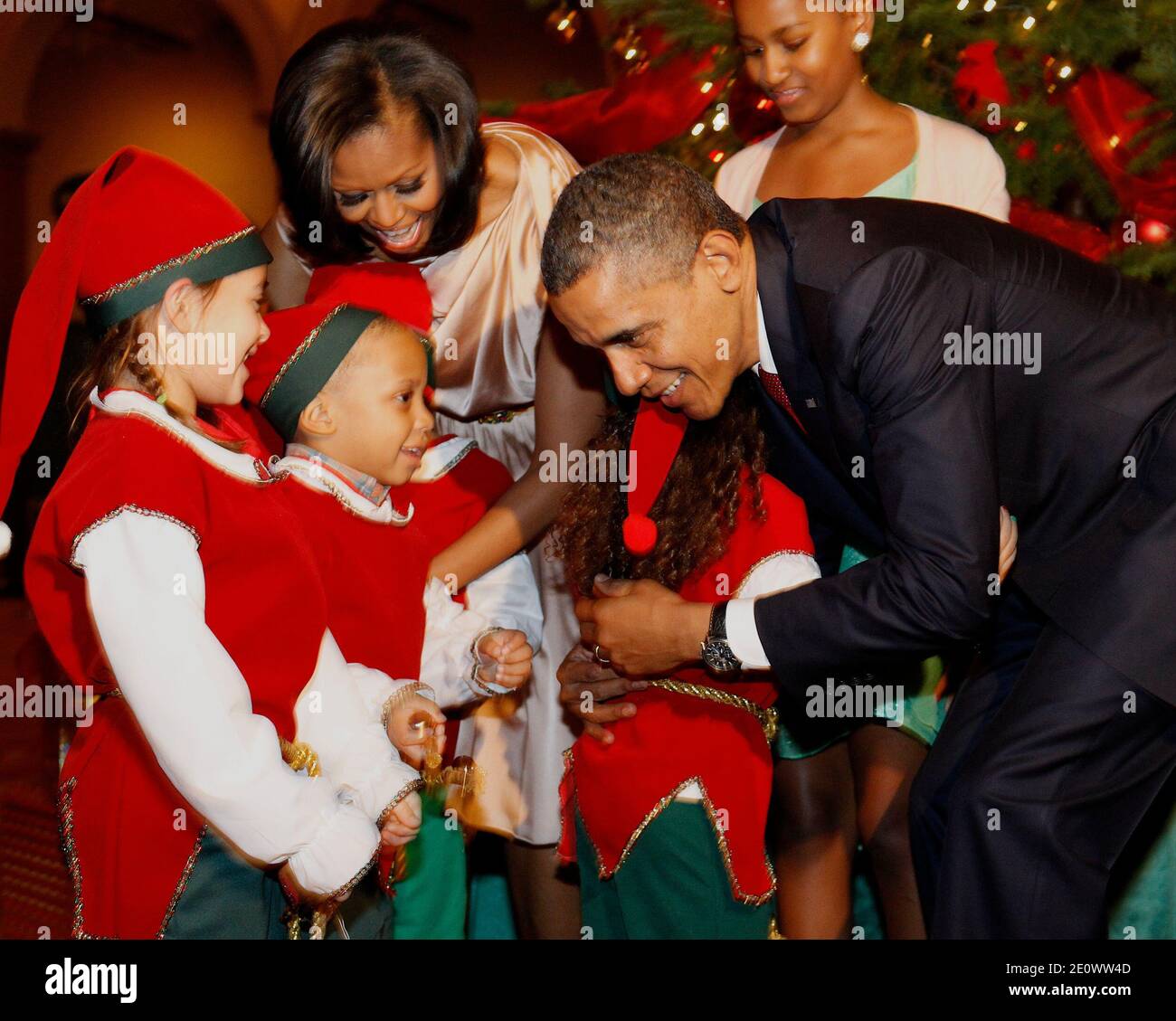President Barack Obama hugs the Christmas elves while attending the ...