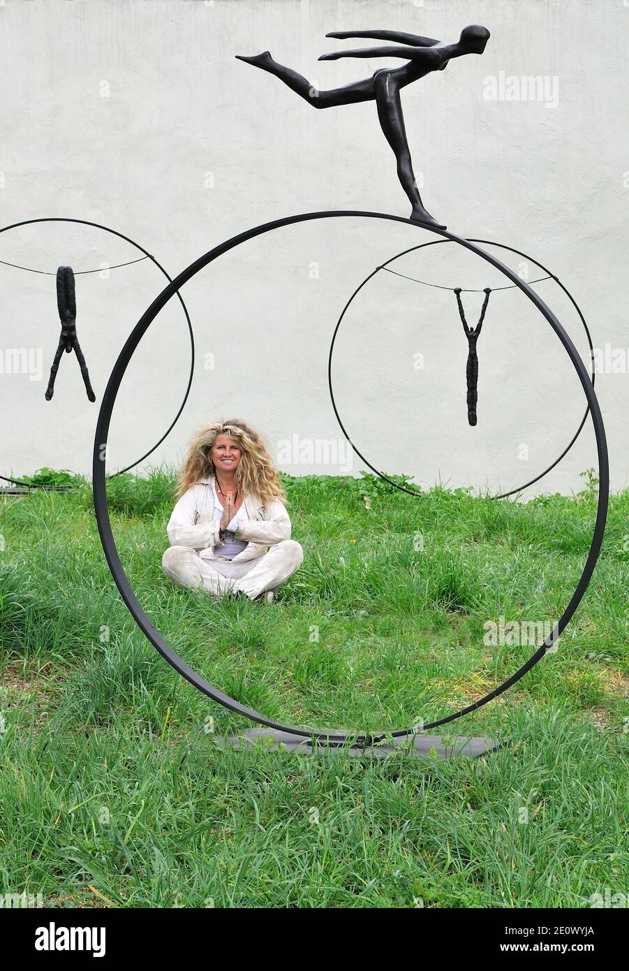 Laying French artist Nathalie Decoster sitting cross-legged in her ...