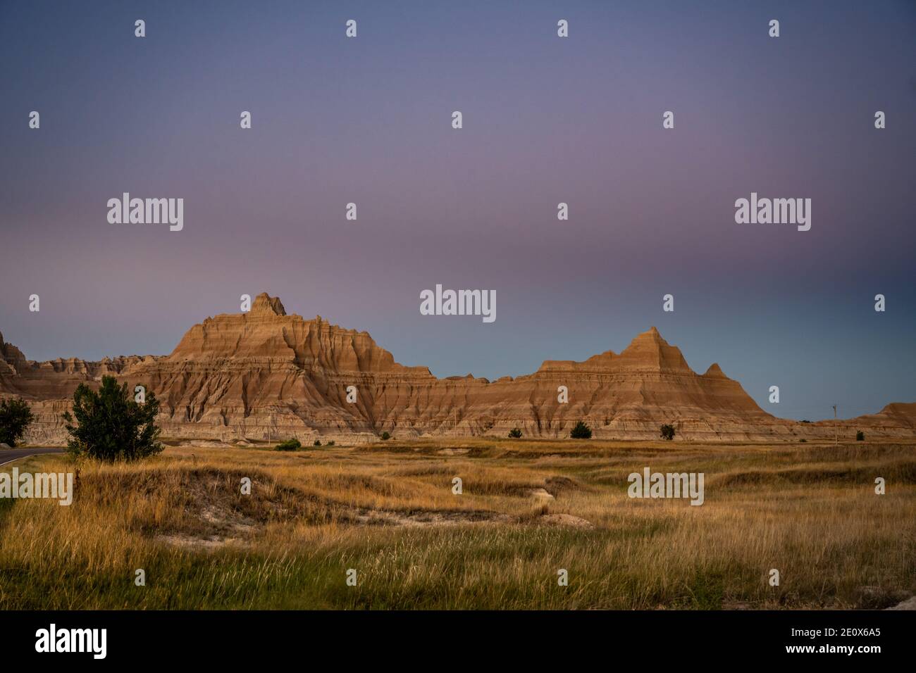 Late Afternoon Light Falls Across Badlands Formation and Field in ...